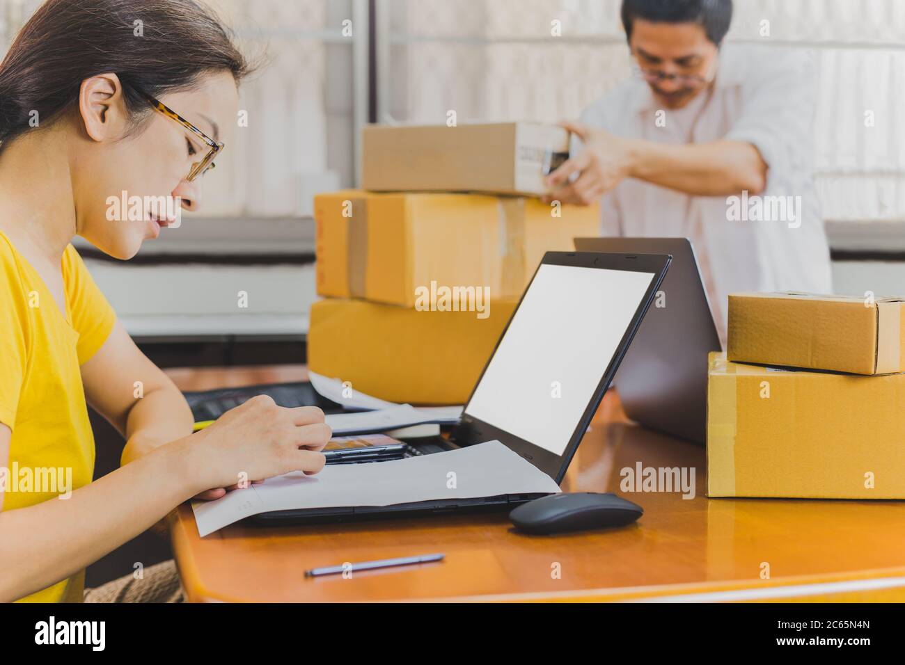 Business couple hand writing address on parcel box work from home Stock ...