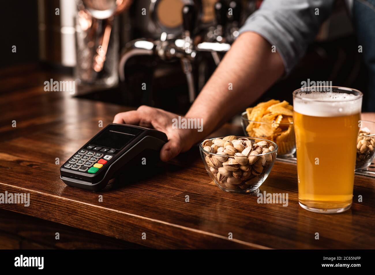 Bartender gives terminal payment hi-res stock photography and images ...