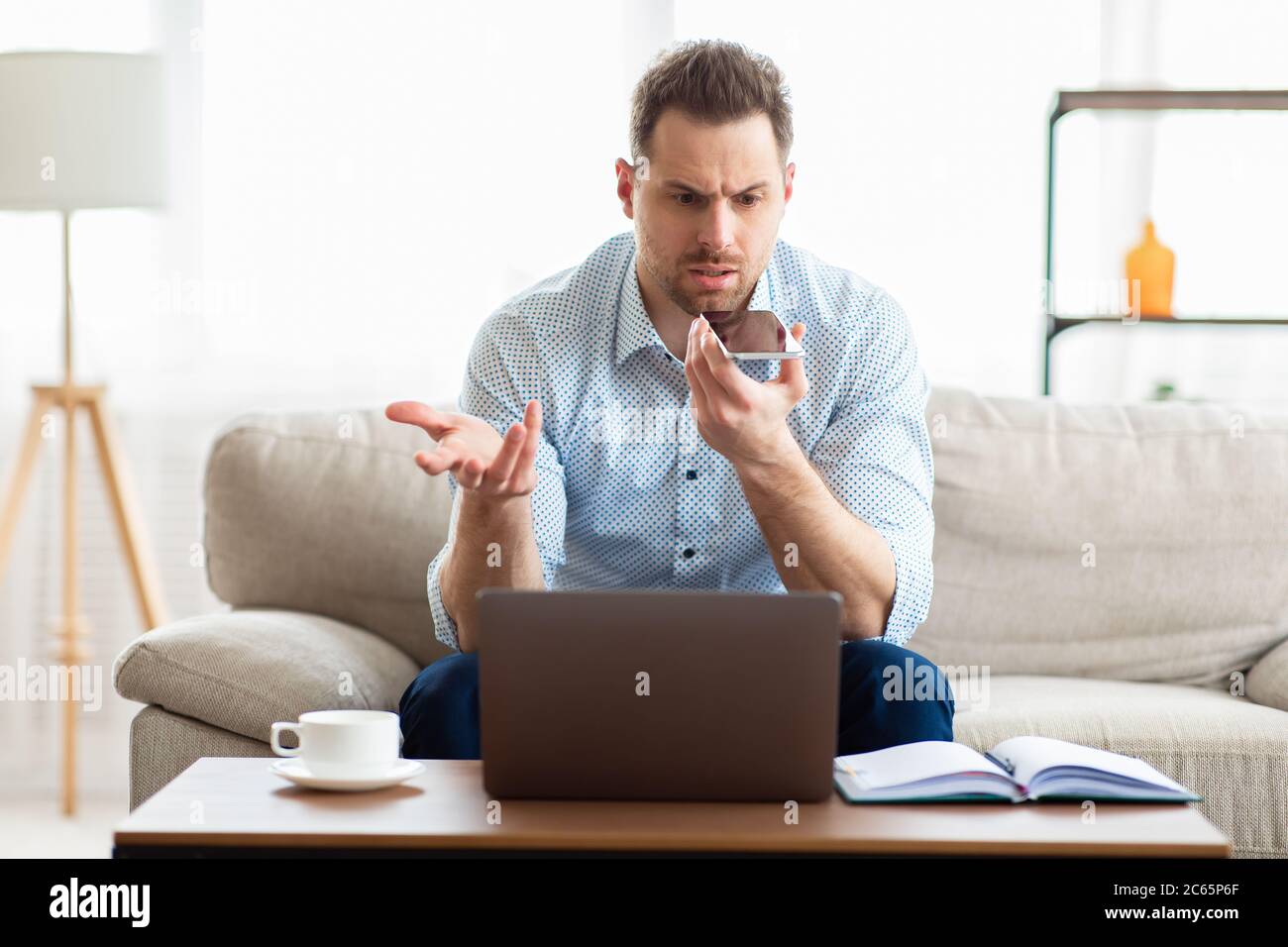 Adult handsome man using voice assistant on smartphone Stock Photo - Alamy