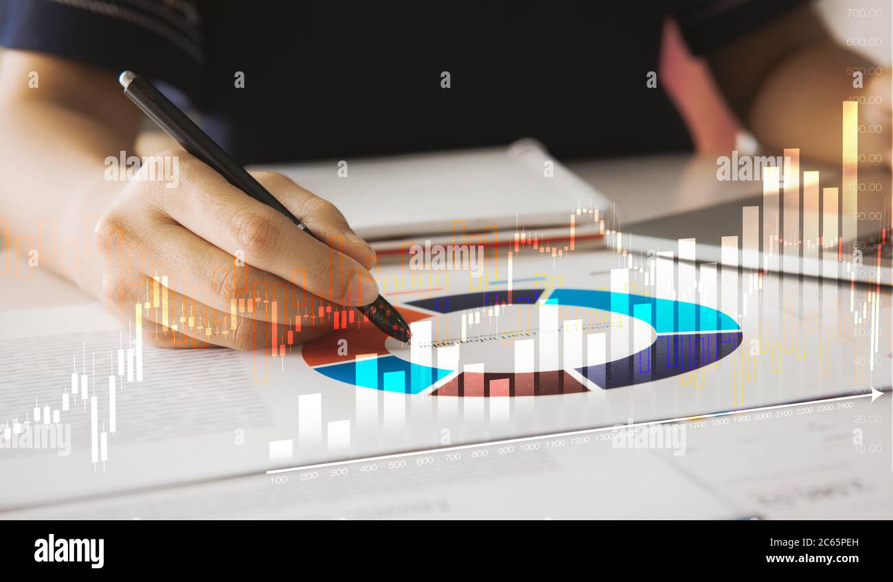 Businesswoman analyzing investment charts with laptop.Business ...