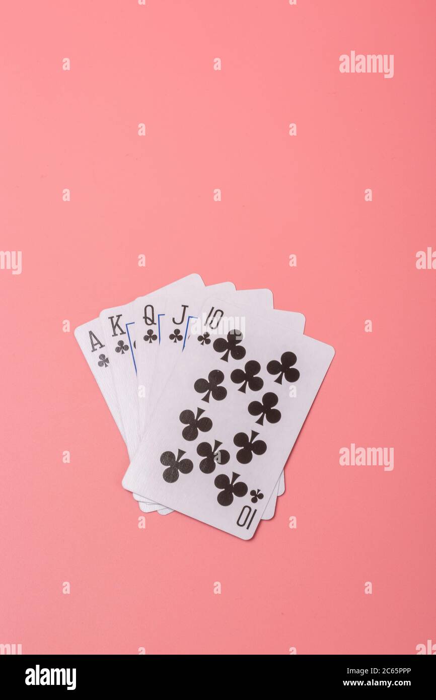 Expanded playing cards on pink background Stock Photo - Alamy