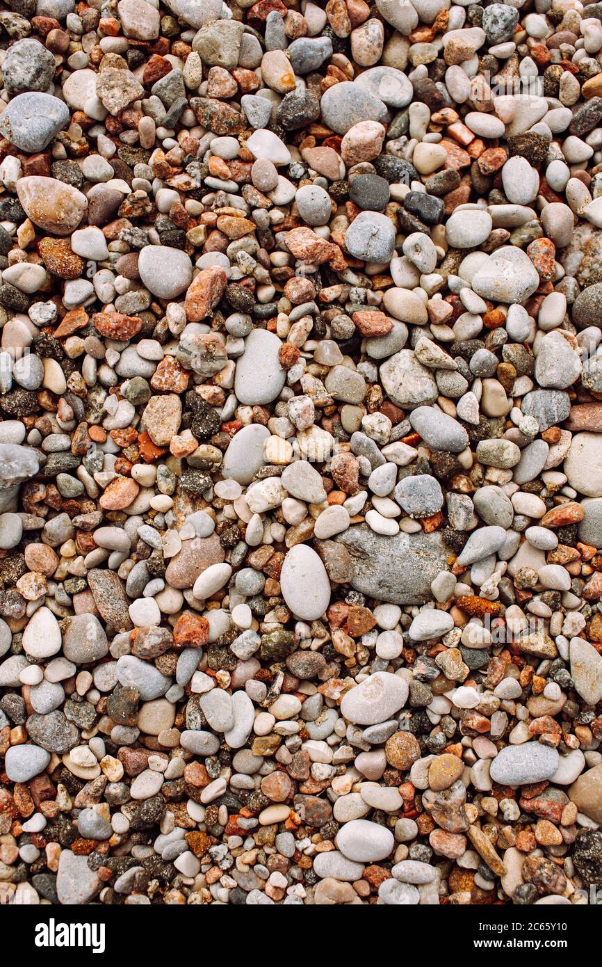 The texture of the little pebbles on the beach. Shoot from above space ...