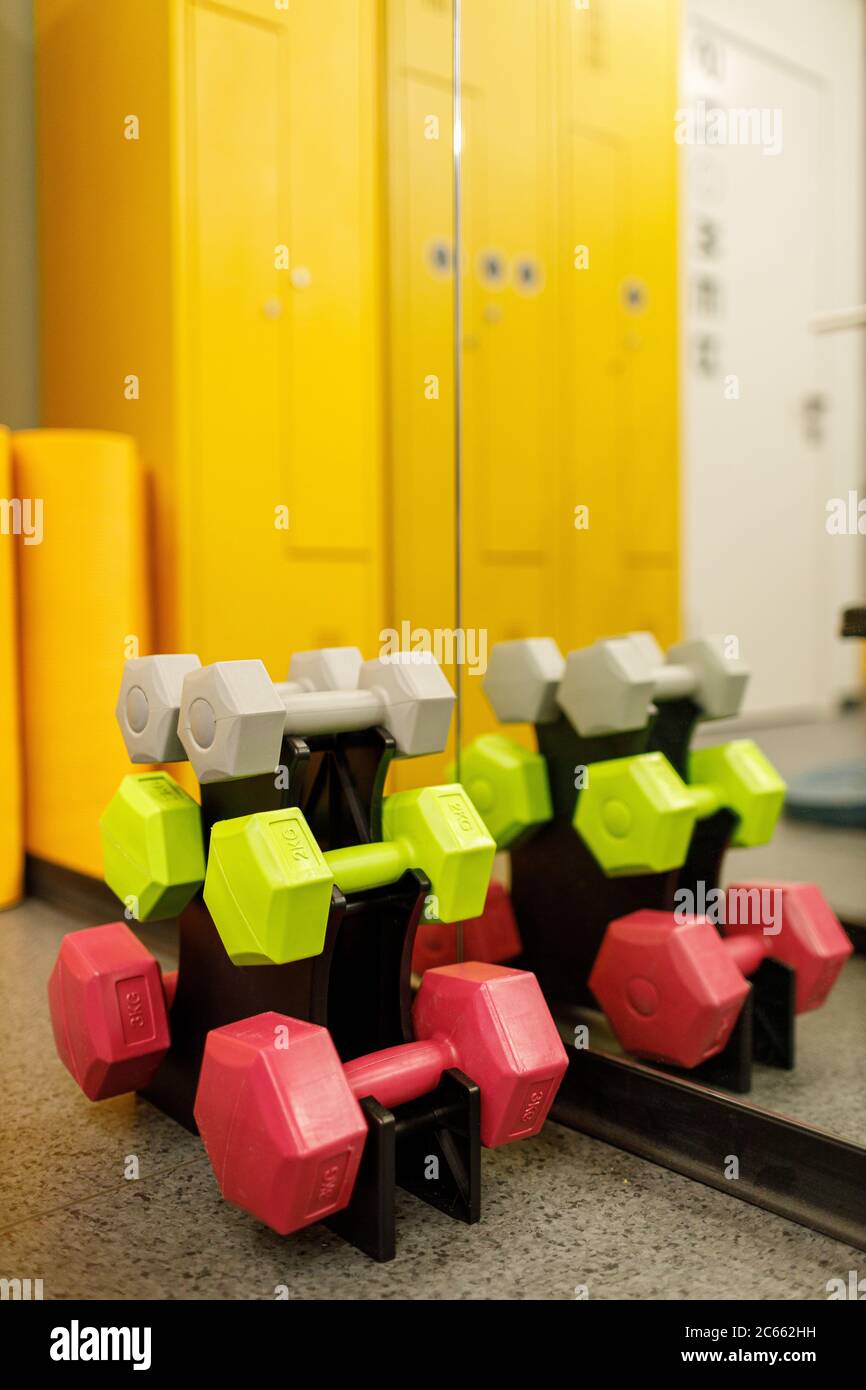 Pyramid of colored dumbbells in the gym Stock Photo - Alamy