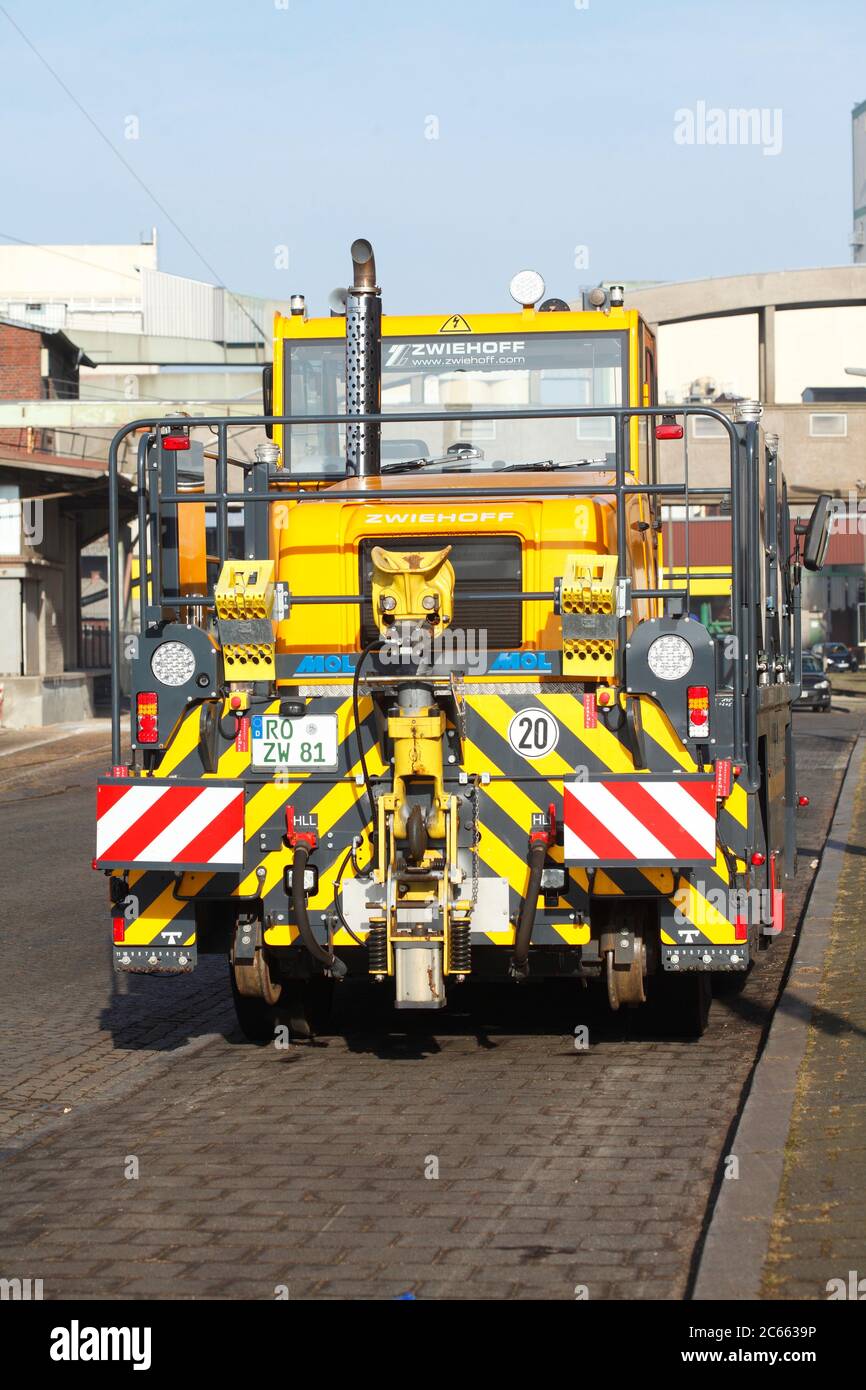 Yellow diesel locomotive, wood and factory harbour, Bremen, Germany ...
