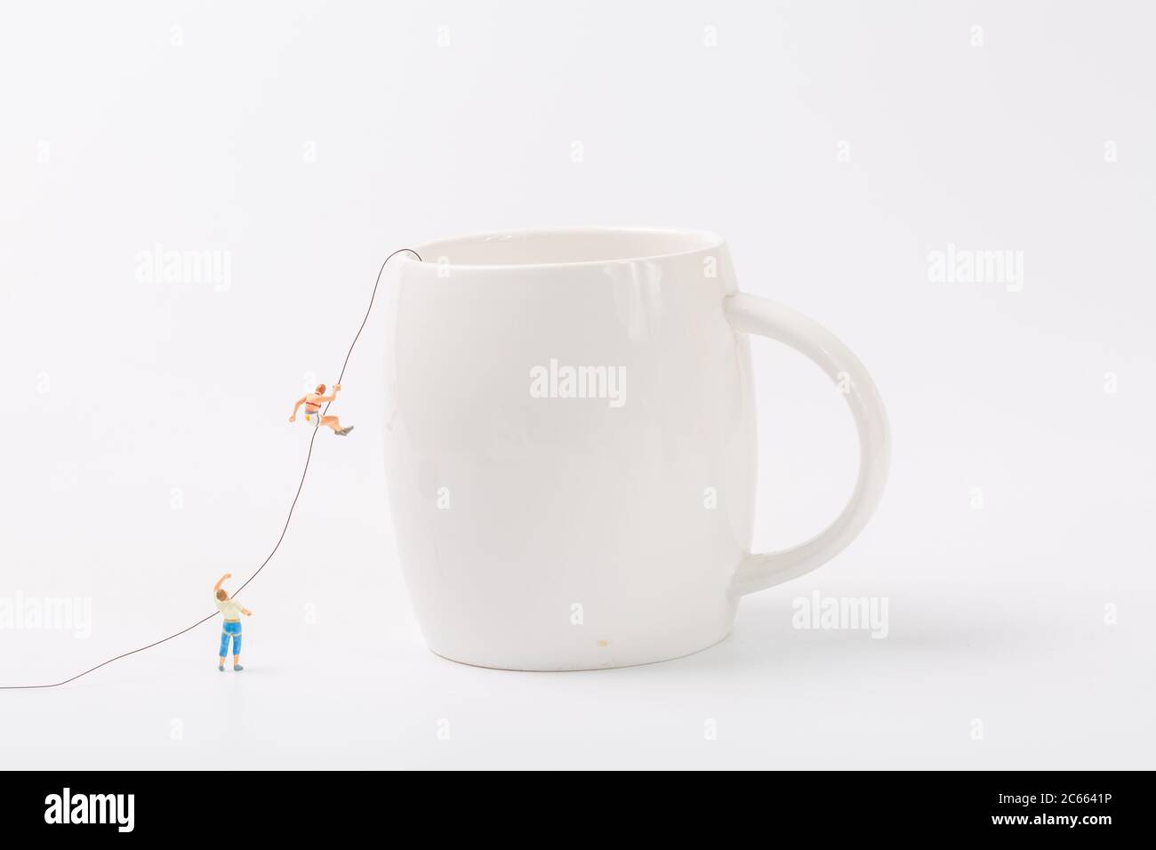 Man climbing cup on white background Stock Photo - Alamy