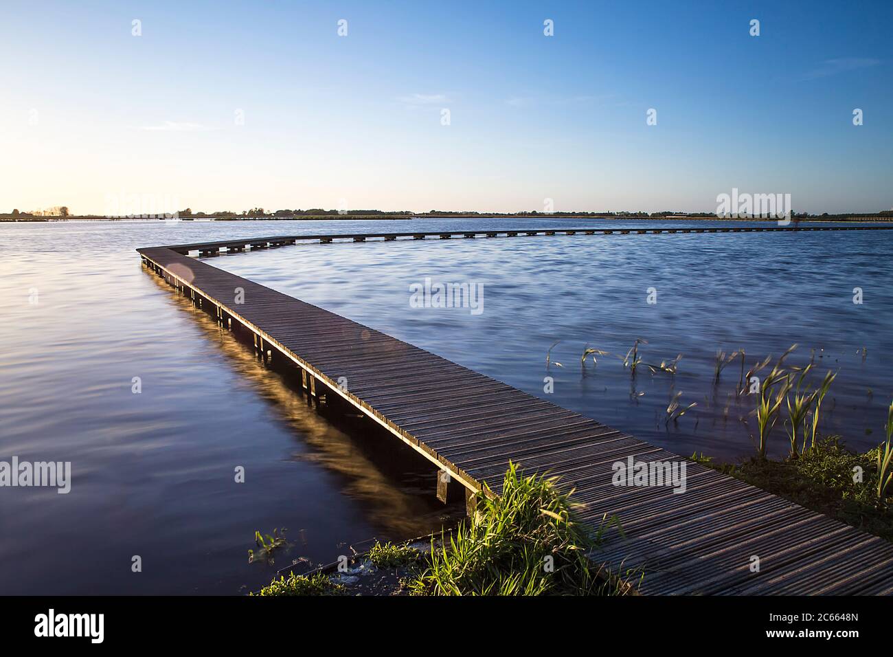 Wooden footbridge over a lake Stock Photo - Alamy