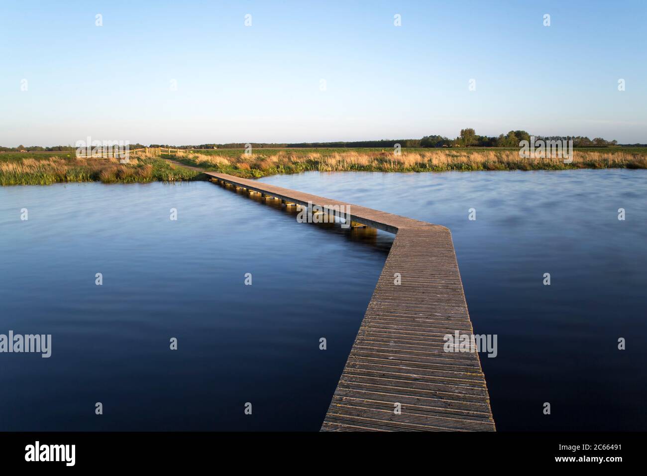Wooden footbridge over a lake Stock Photo - Alamy