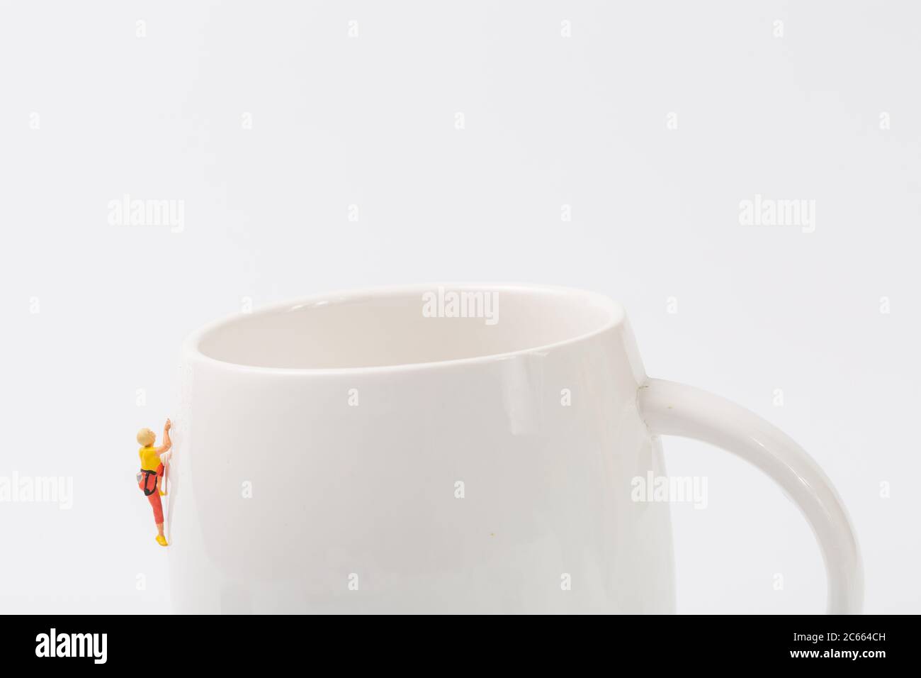 Man climbing cup on white background Stock Photo - Alamy