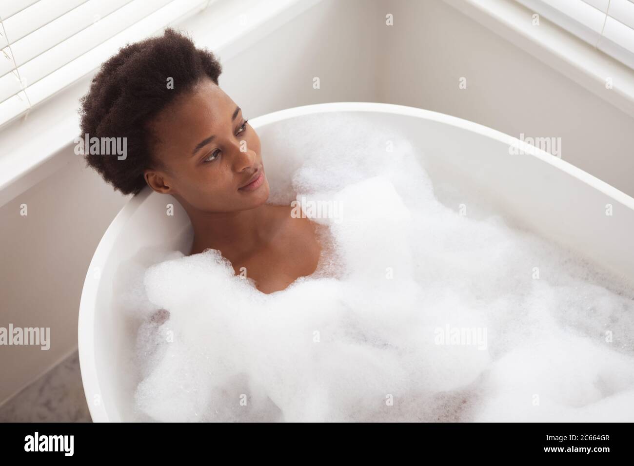Woman relaxing in a bathtub Stock Photo - Alamy