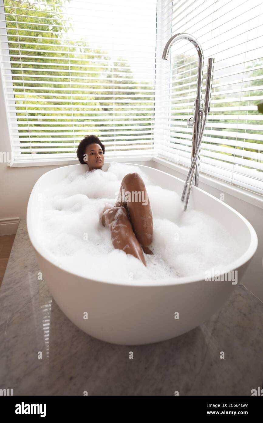 Woman relaxing in a bathtub Stock Photo - Alamy