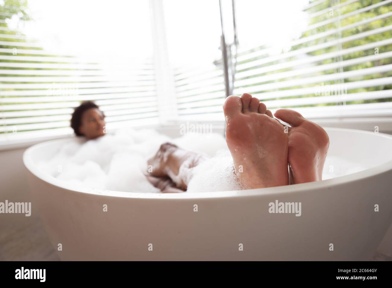 Woman relaxing in a bathtub Stock Photo - Alamy