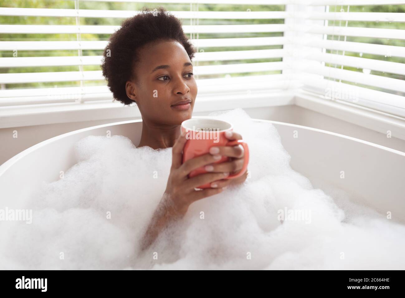 Young woman touching water bathtub hi-res stock photography and images - Alamy