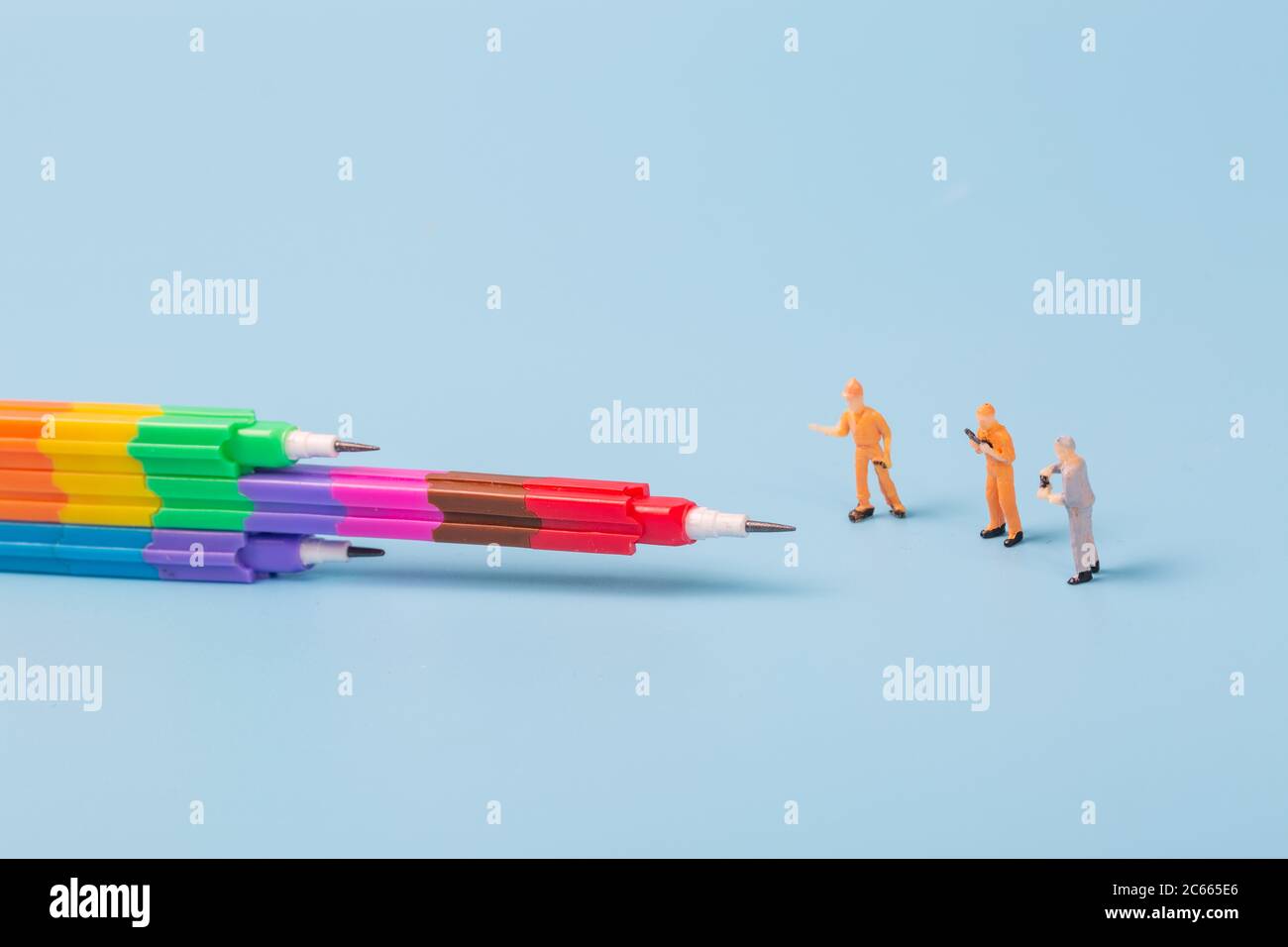 Pencil and man on blue background Stock Photo - Alamy