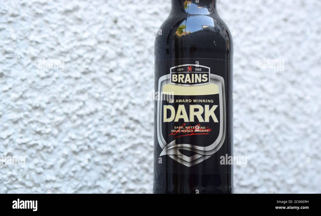 Dark beer bottle from Brains brewery on light textured background Stock ...