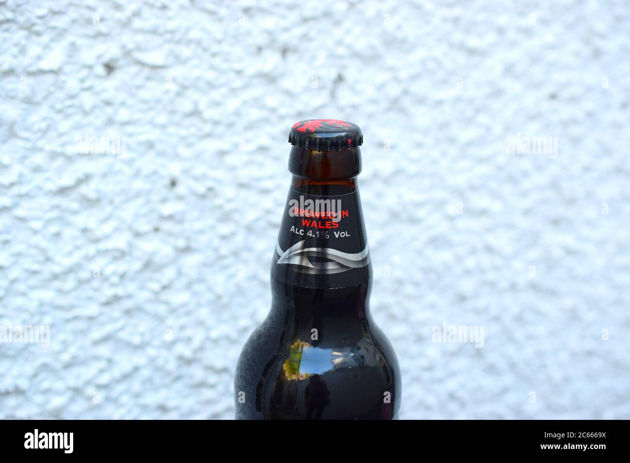 Dark beer bottle from Brains brewery on light textured background Stock ...
