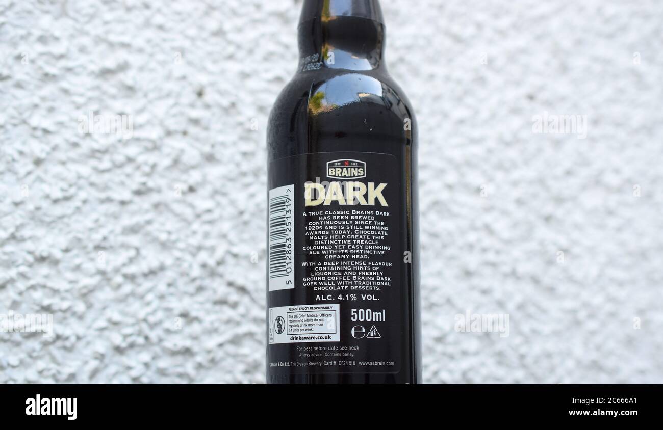 Dark beer bottle from Brains brewery on light textured background Stock ...