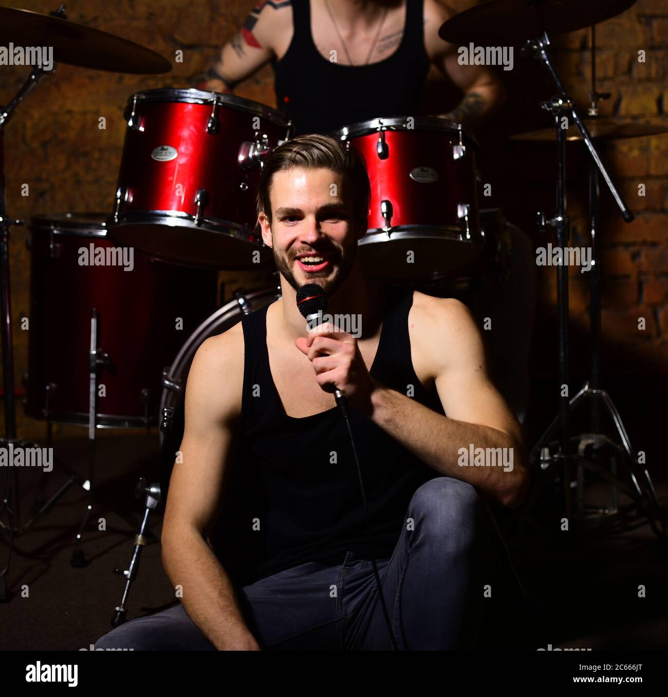 Man with beard sings on bar instruments background. Singer or star with ...