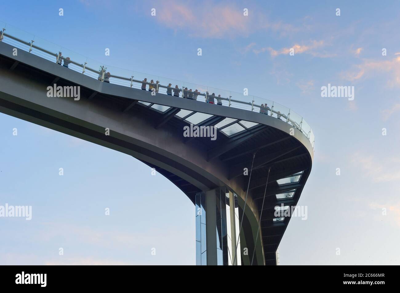 Crowd of people at new Pedestrian-Bicycle Bridge at sunset. New ...