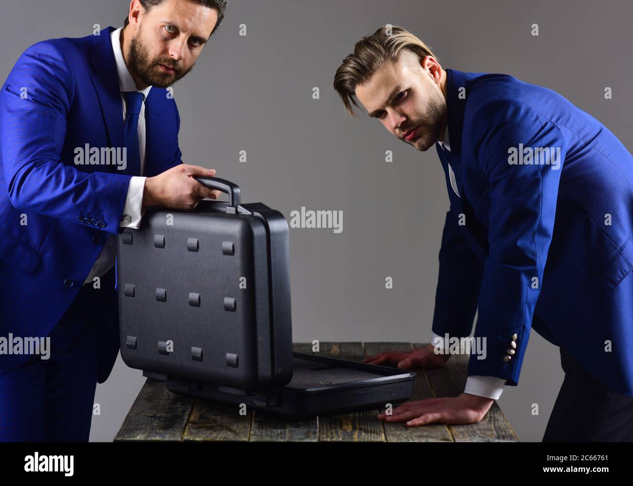 Businessman transfer deal, business black briefcase exchange dark ...