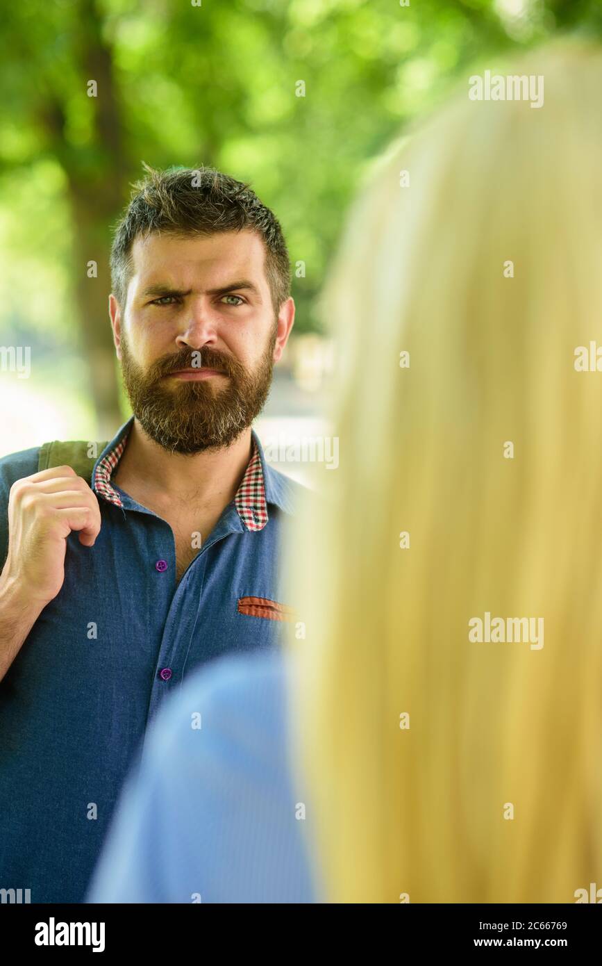 First meet of strangers, man with beard looks at blonde girl. Love at ...