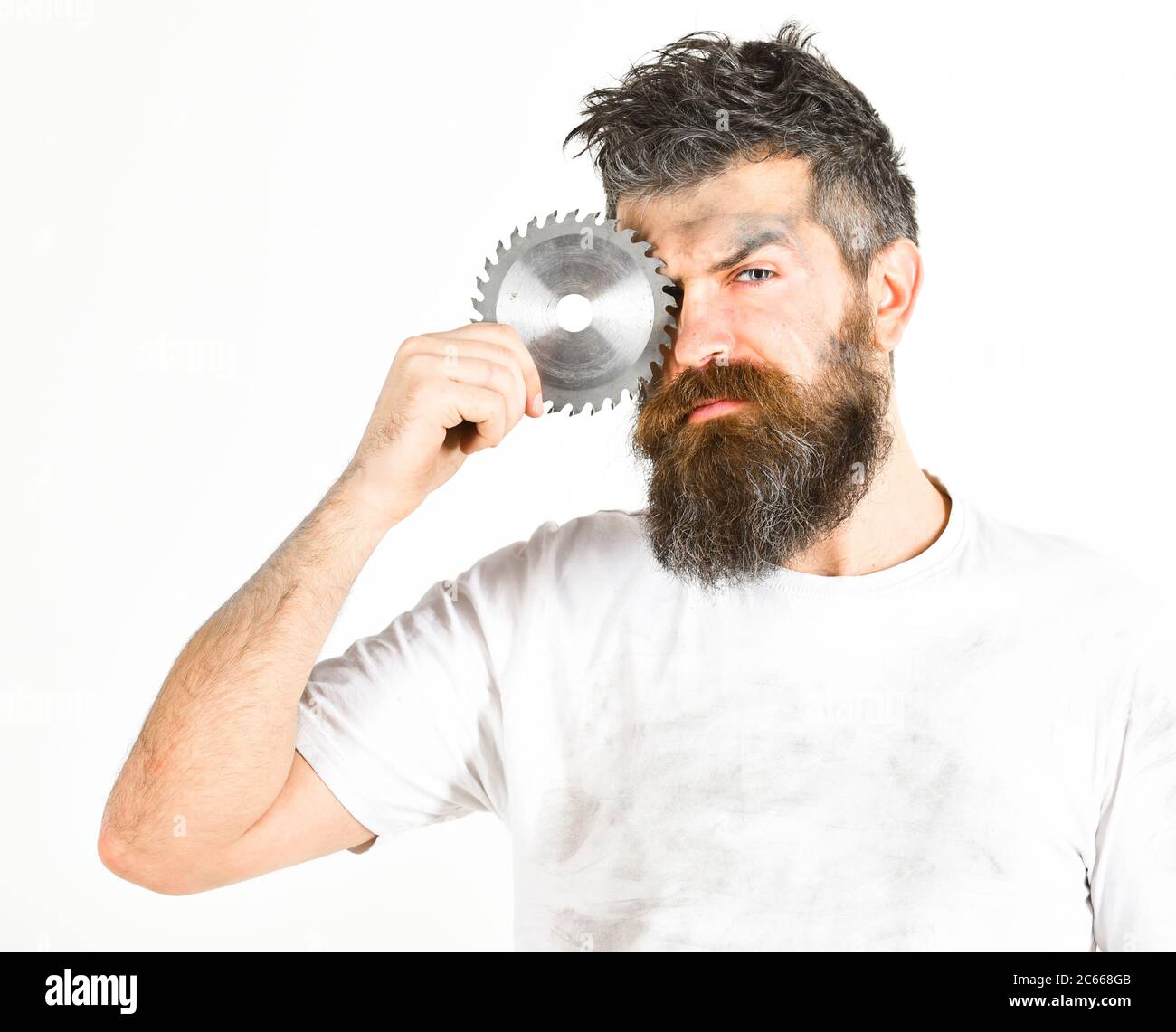 Repairman, foreman holds circular saw blade in front of his face. Sharp ...