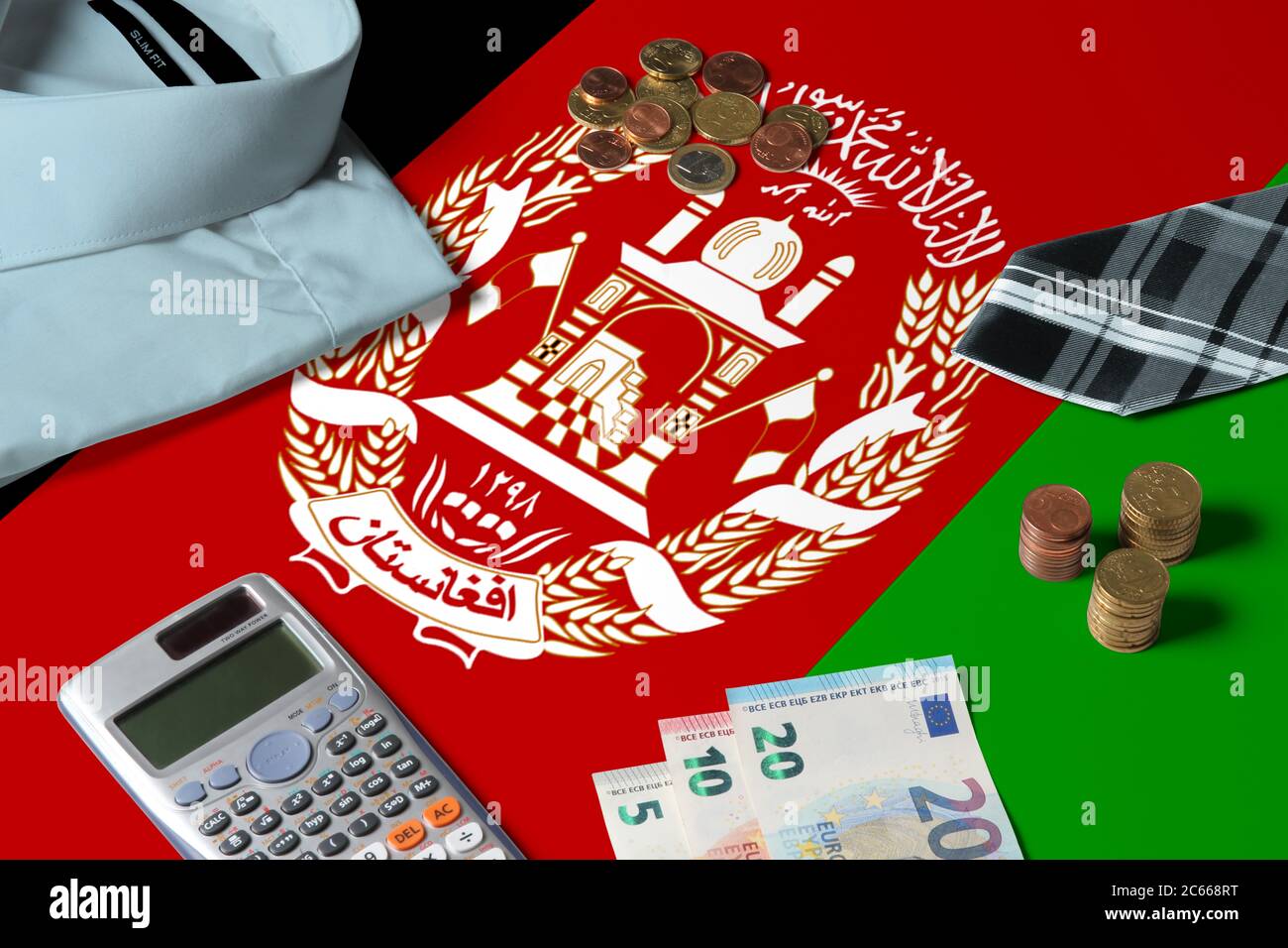 Afghanistan flag on minimal money concept table. Coins and financial ...