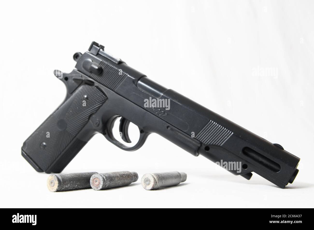 Pistol Gun and Bullets on a White Background Stock Photo - Alamy