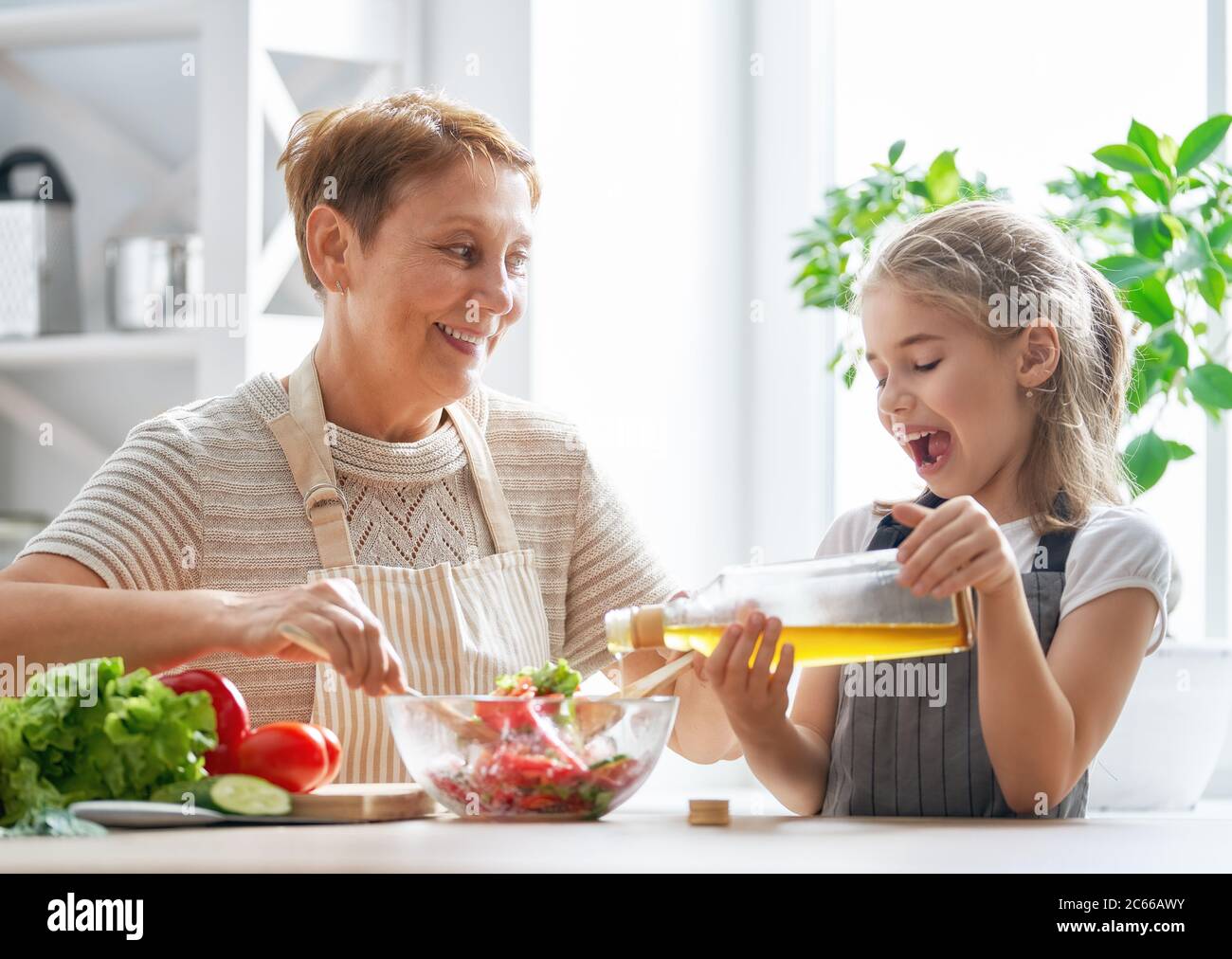 Healthy food at home. Happy family in the kitchen. Grandma and child ...