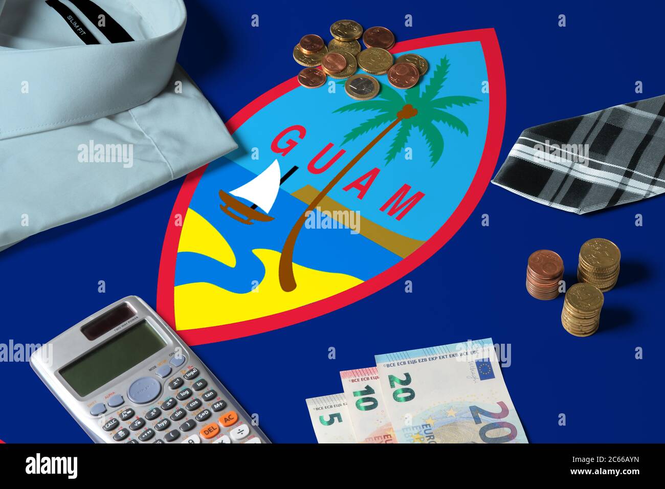 Guam flag on minimal money concept table. Coins and financial objects ...