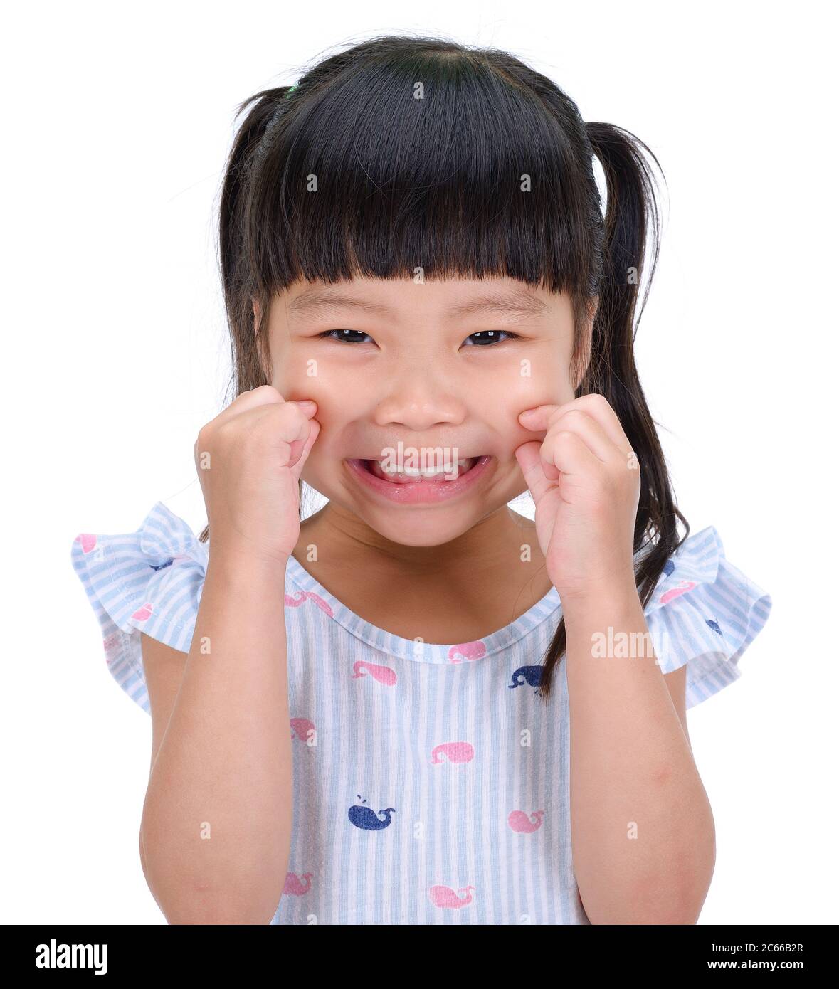 little Asian girl touch her cheek and smile on white background Stock ...