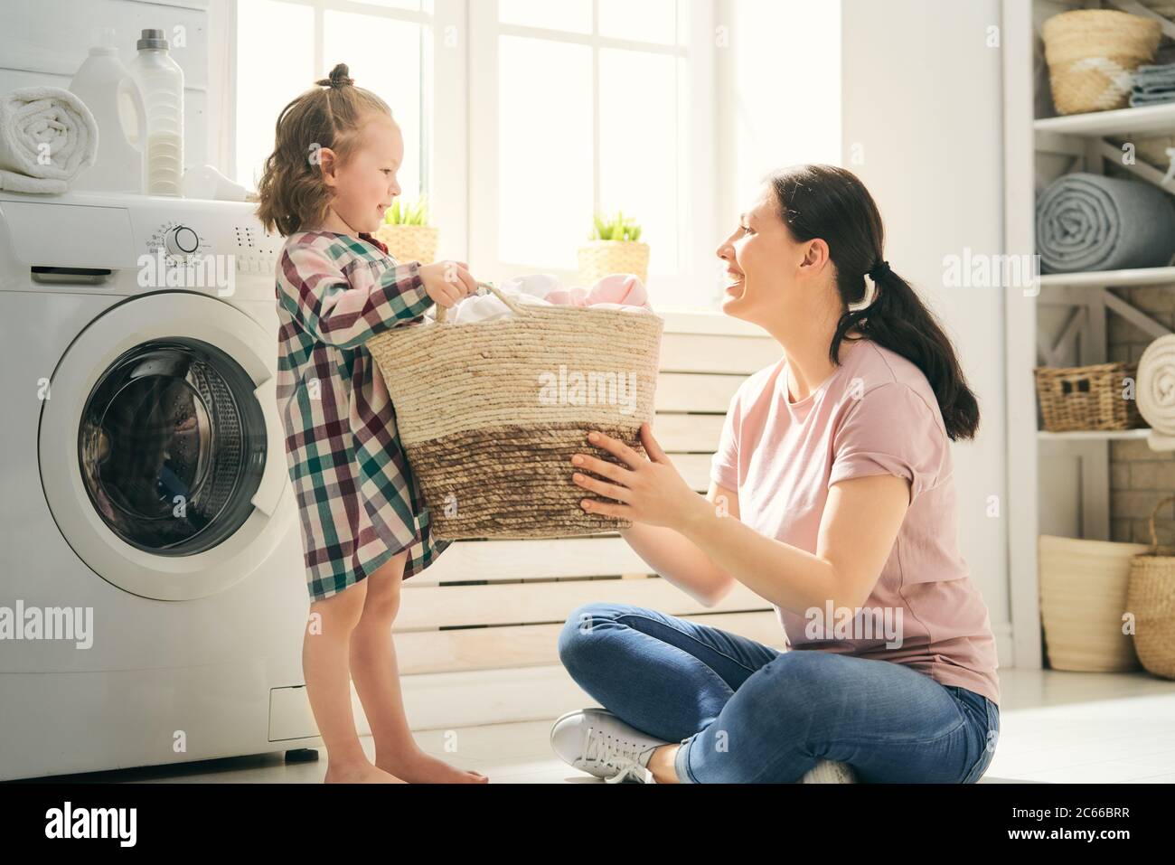 Beautiful young woman and child girl little helper are having fun and ...