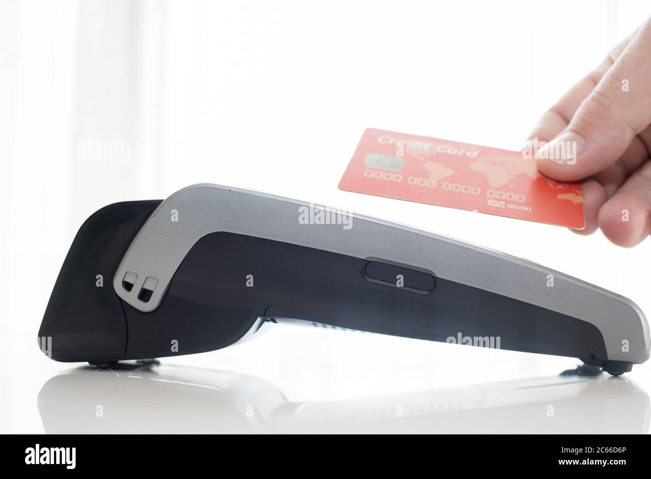 red Credit Card And Pos Terminal On White Stock Photo - Alamy