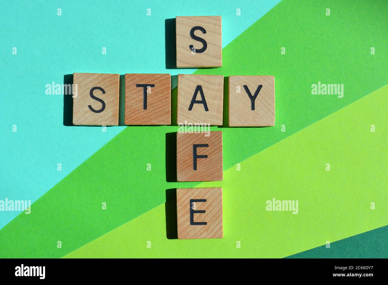 Stay Safe in 3D wooden alphabet letters isolated on a green background ...