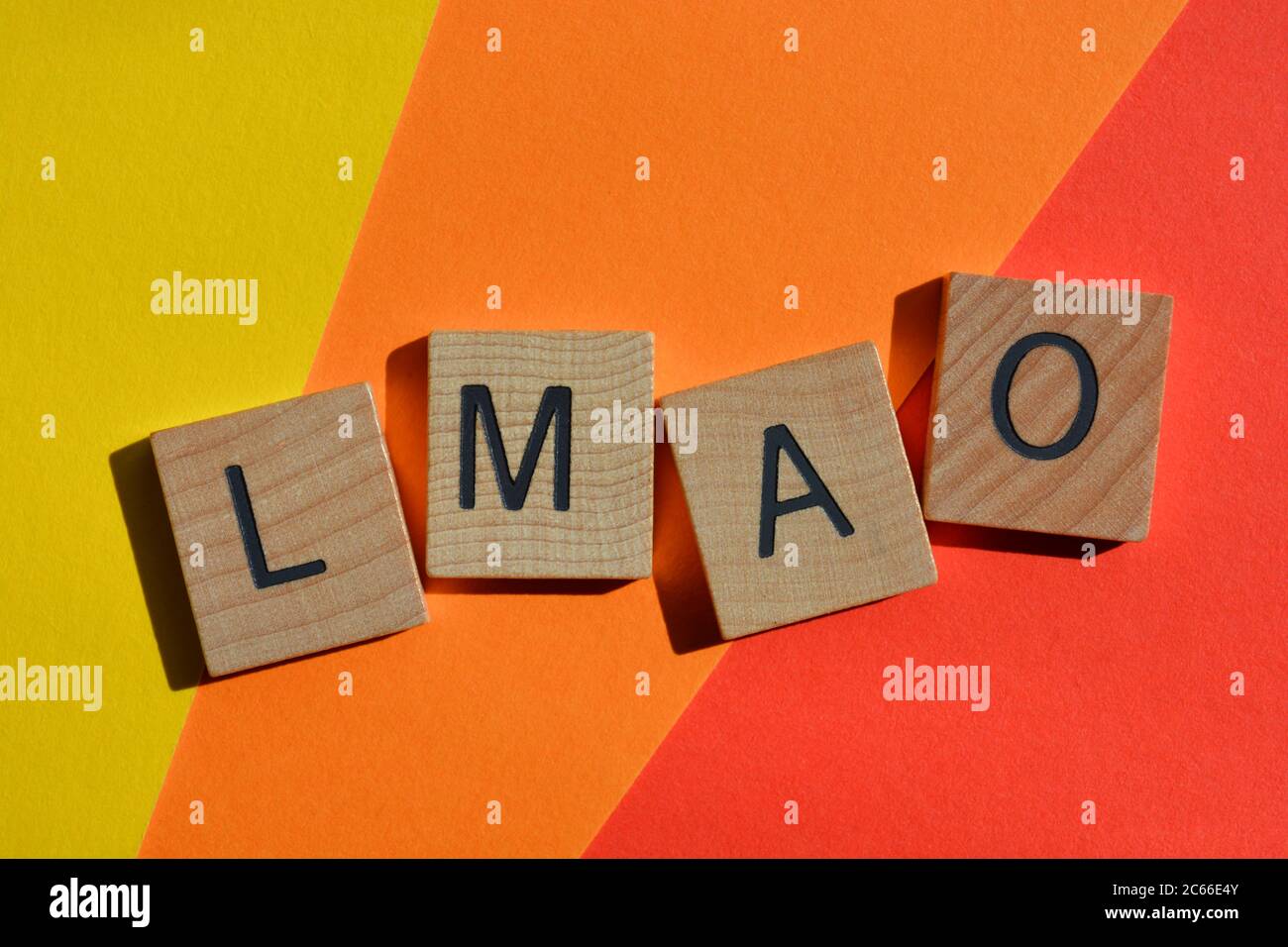Internet Slang, LMAO in 3d wooden alphabet letters isolated on colorful ...