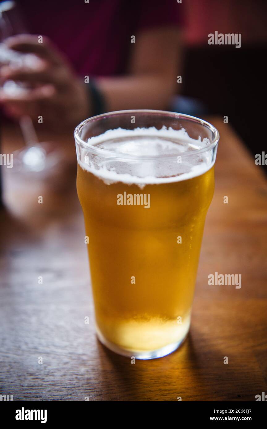 glass of beer in a bar setting Stock Photo - Alamy