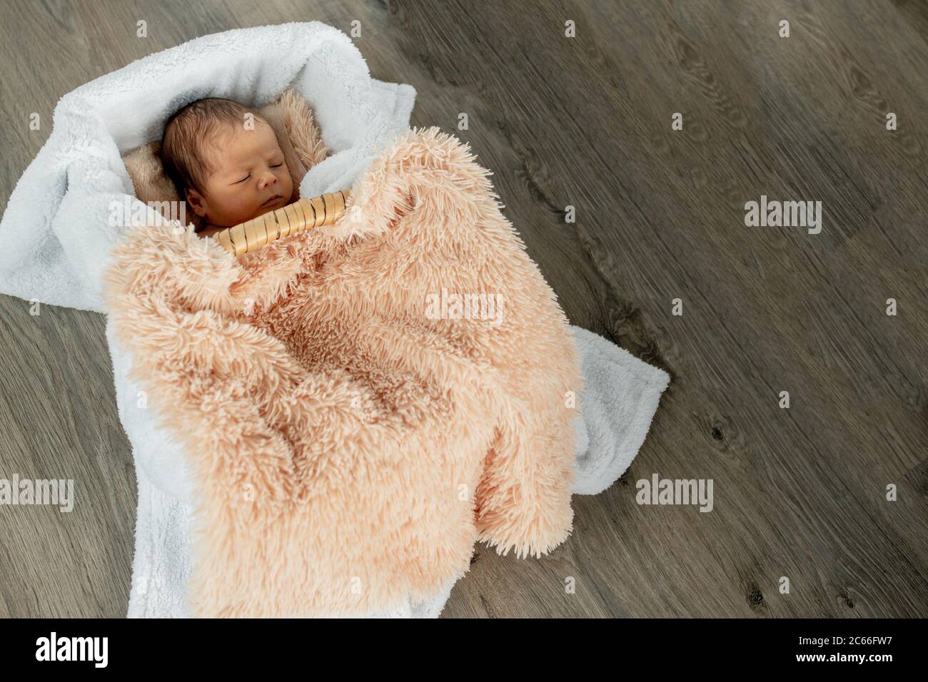 Two week old newborn baby boy sleeping in a vintage wooden box. Shot in ...