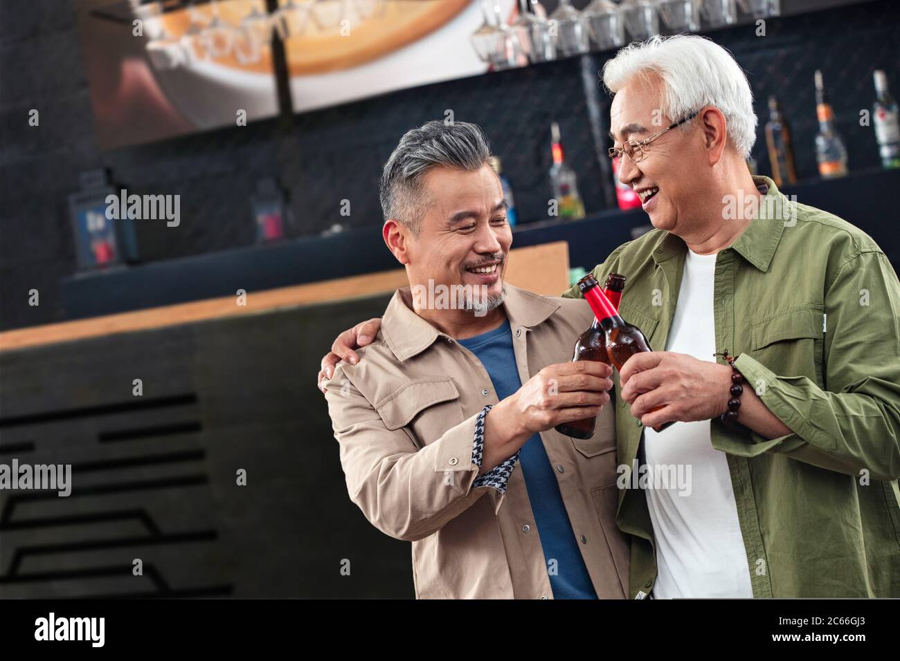 Happy old brothers to drink beer Stock Photo - Alamy