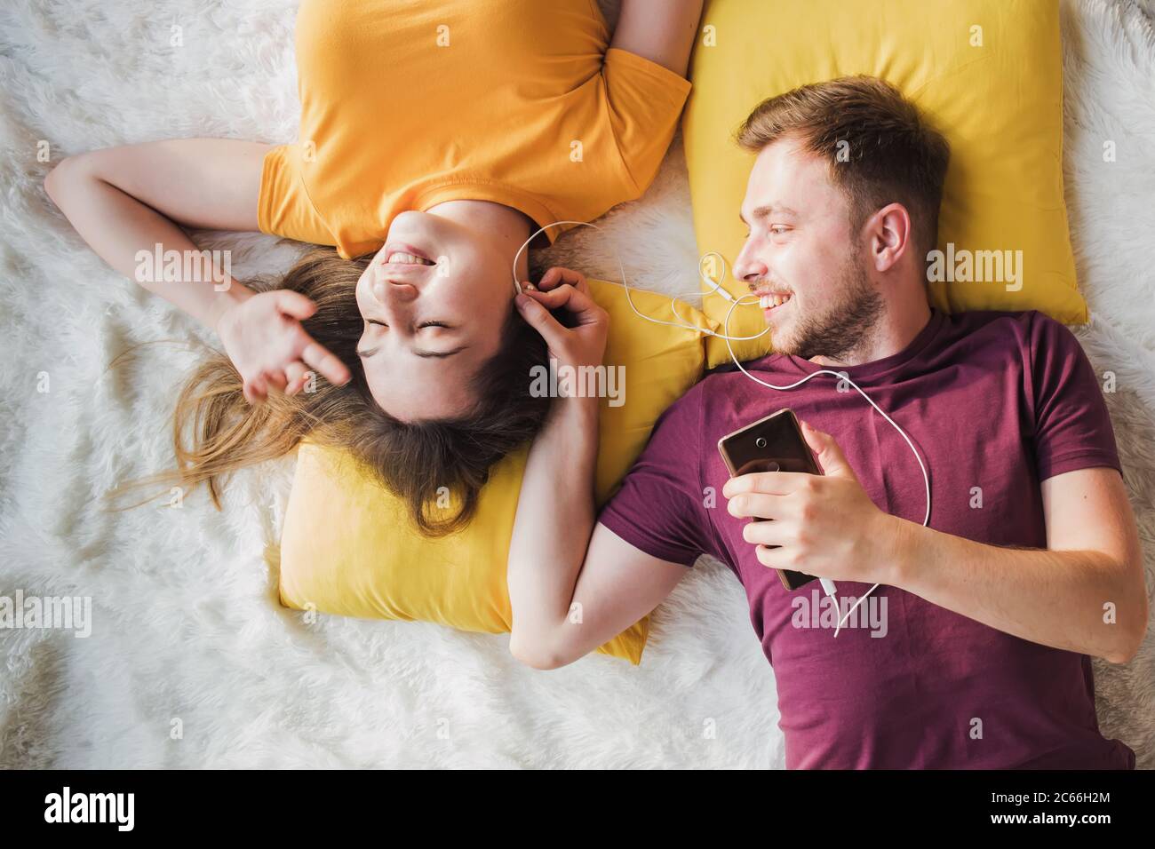 Couple sharing headphones hi-res stock photography and images - Alamy