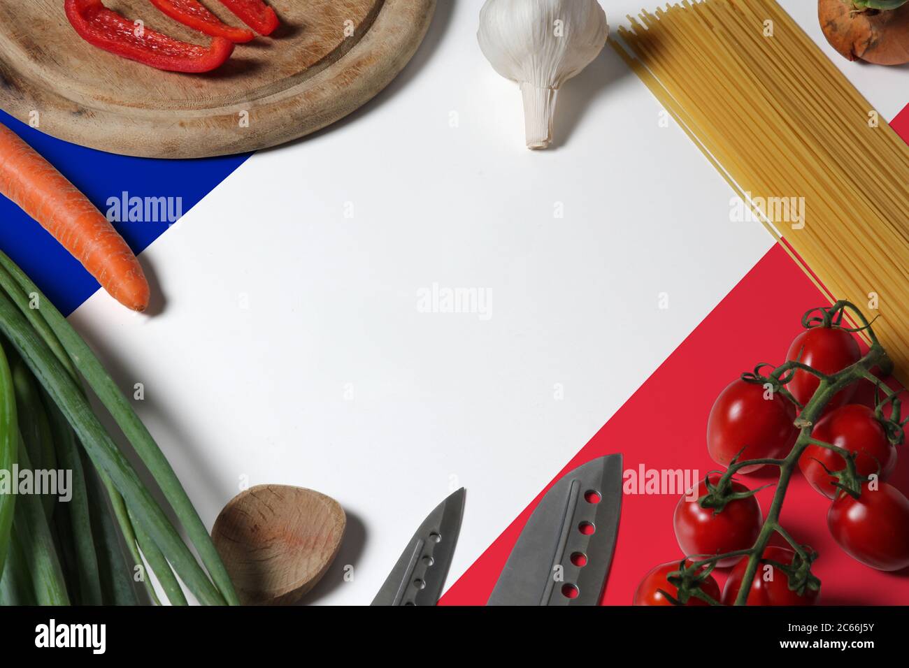 France flag on fresh vegetables and knife concept wooden table. Cooking ...