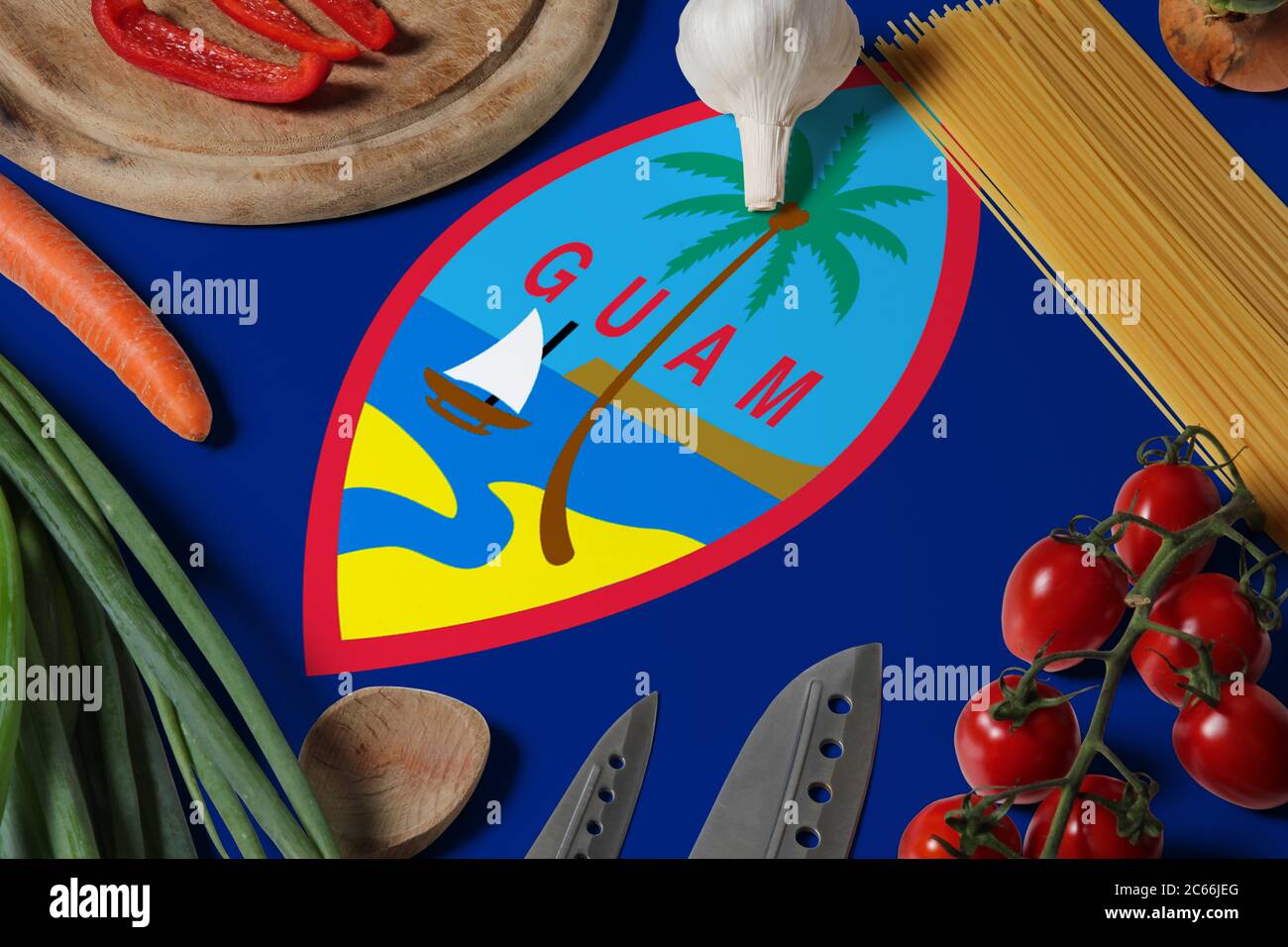 Guam flag on fresh vegetables and knife concept wooden table. Cooking ...