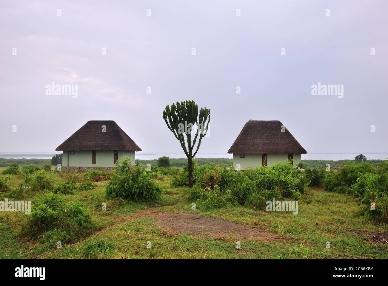 Traditional huts on the lake George coastline shown at misty sunrise ...