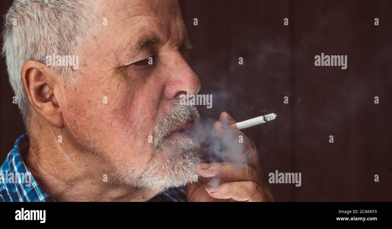 Senior man smoking cigarette outside, the cigarette addiction ...