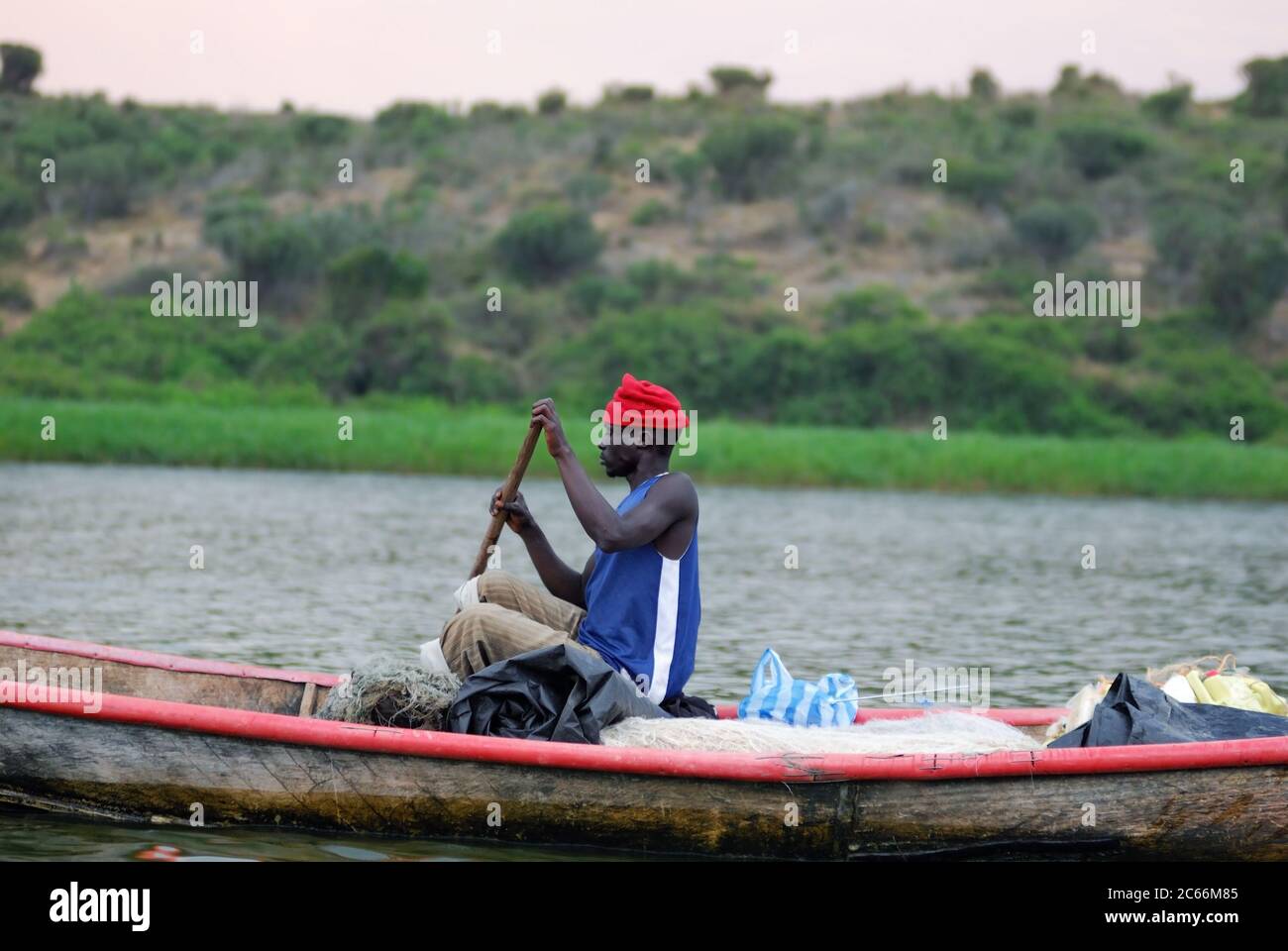 UGANDA - AUG 29, 2010: Fisherman in a boat moving on the Victoria Nile ...