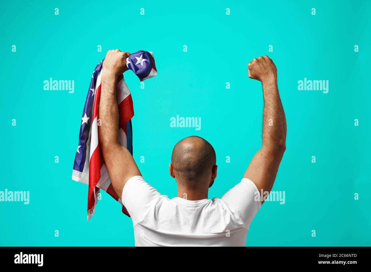 Back view of a black man holding USA flag Stock Photo - Alamy