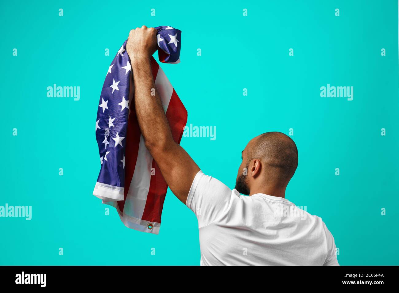 Back view of a black man holding USA flag Stock Photo - Alamy