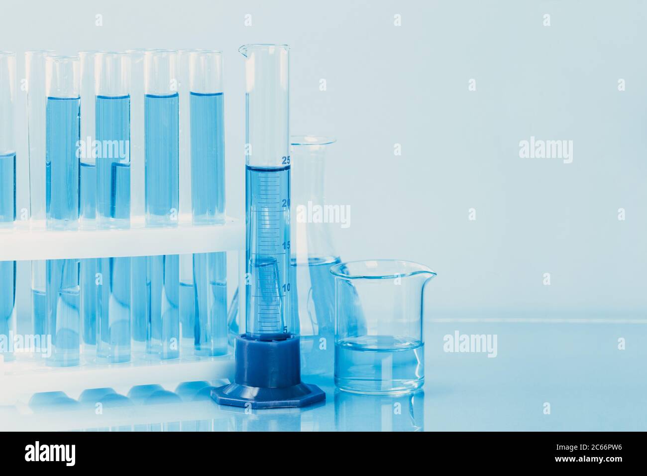 Laboratory glassware with a pipette and test tubes. scientific ...