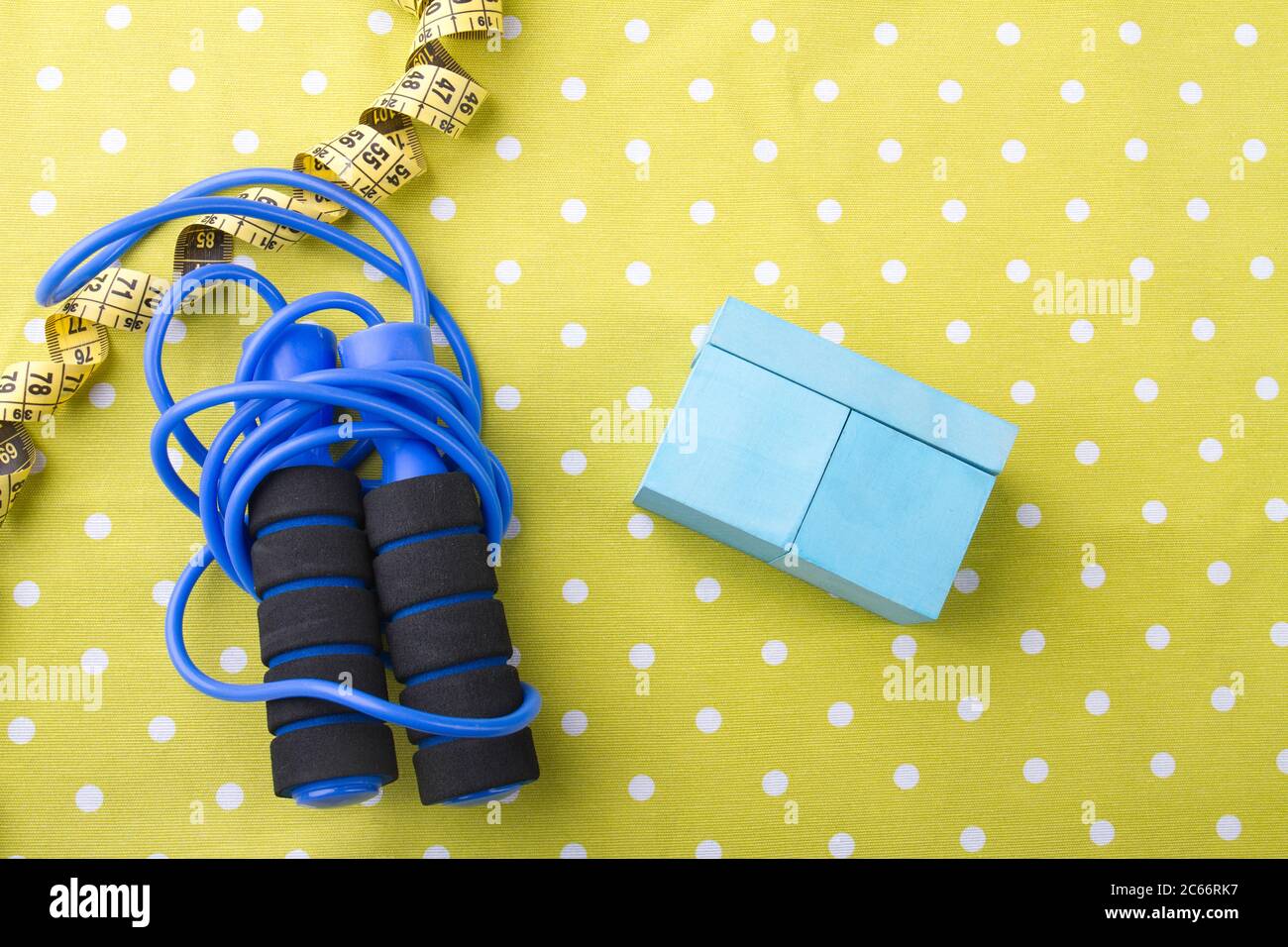 Skipping rope with measuring tape and cupboard on dotted yellow ...