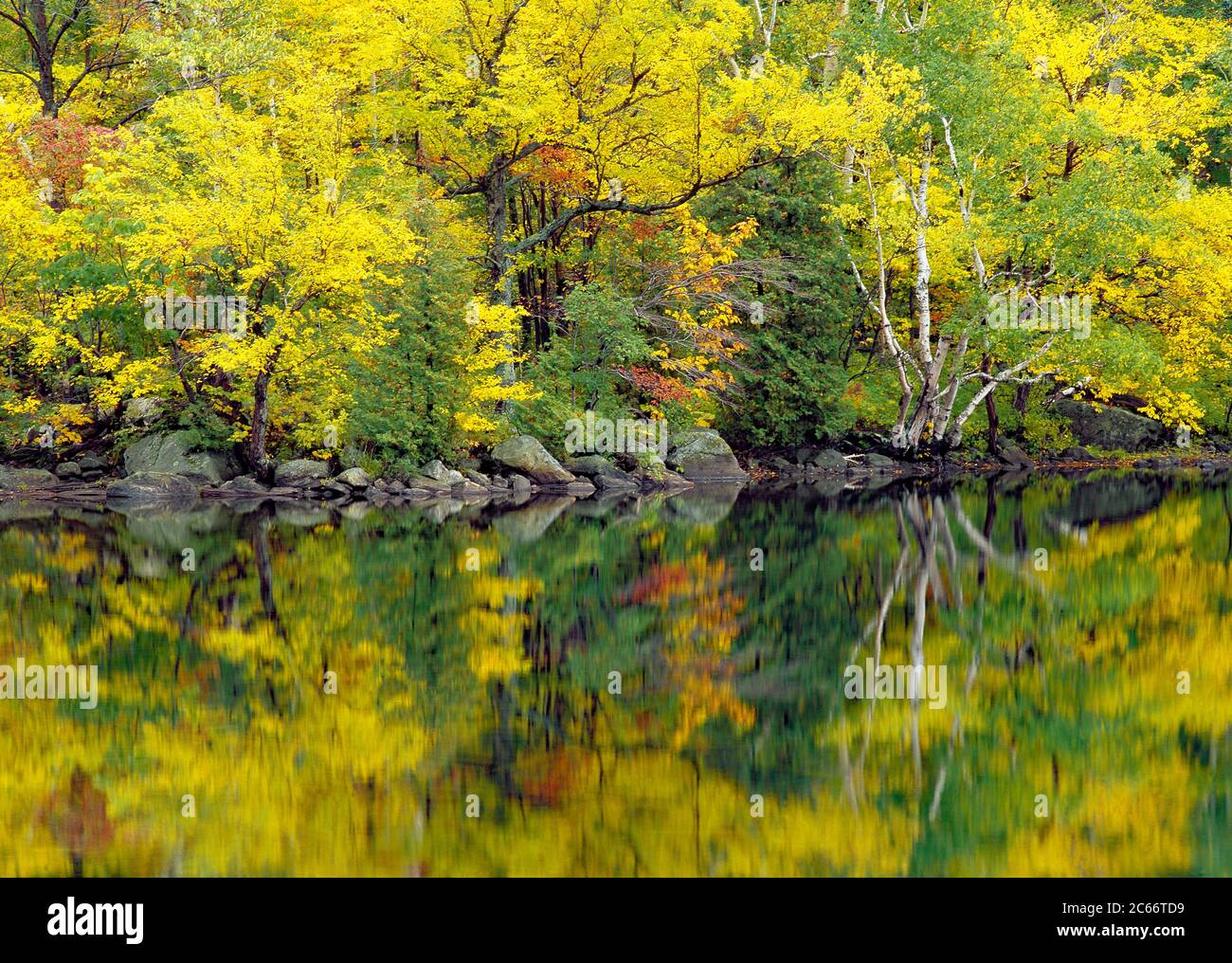 Autumn foliage reflective in Upper Cascade Lake in New York’s ...