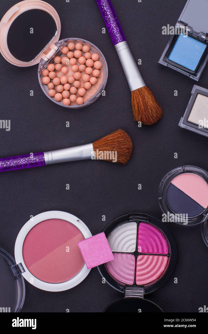 Various makeup products on black background Stock Photo - Alamy