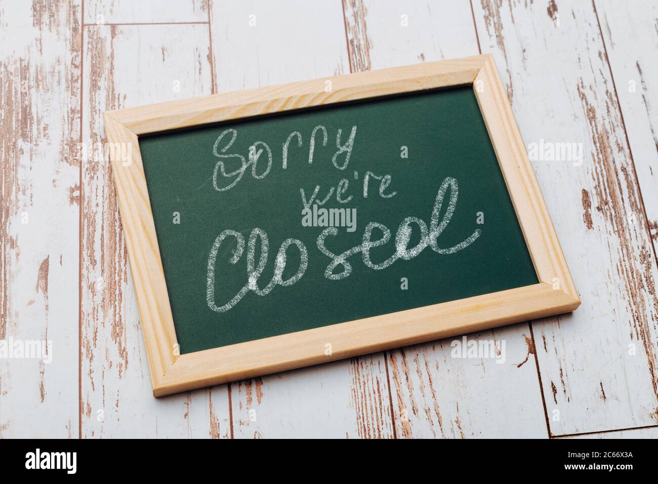 Sign "Sorry, we are closed" on a chalk board with English inscriptions ...